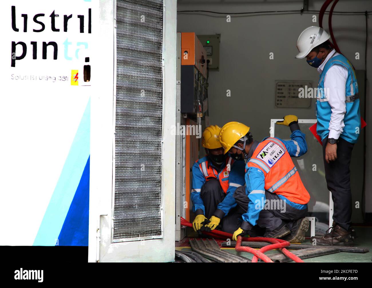 Officers (state electricity company) PLN carry out maintenance of a 20 ...