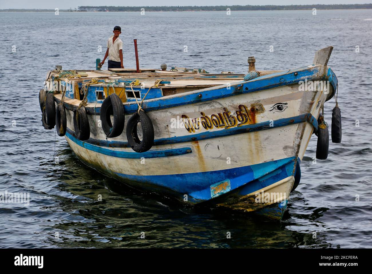 Ferry boat (passengers are seated inside below deck) arrives at the Kanaki Harbour in the Jaffna ...