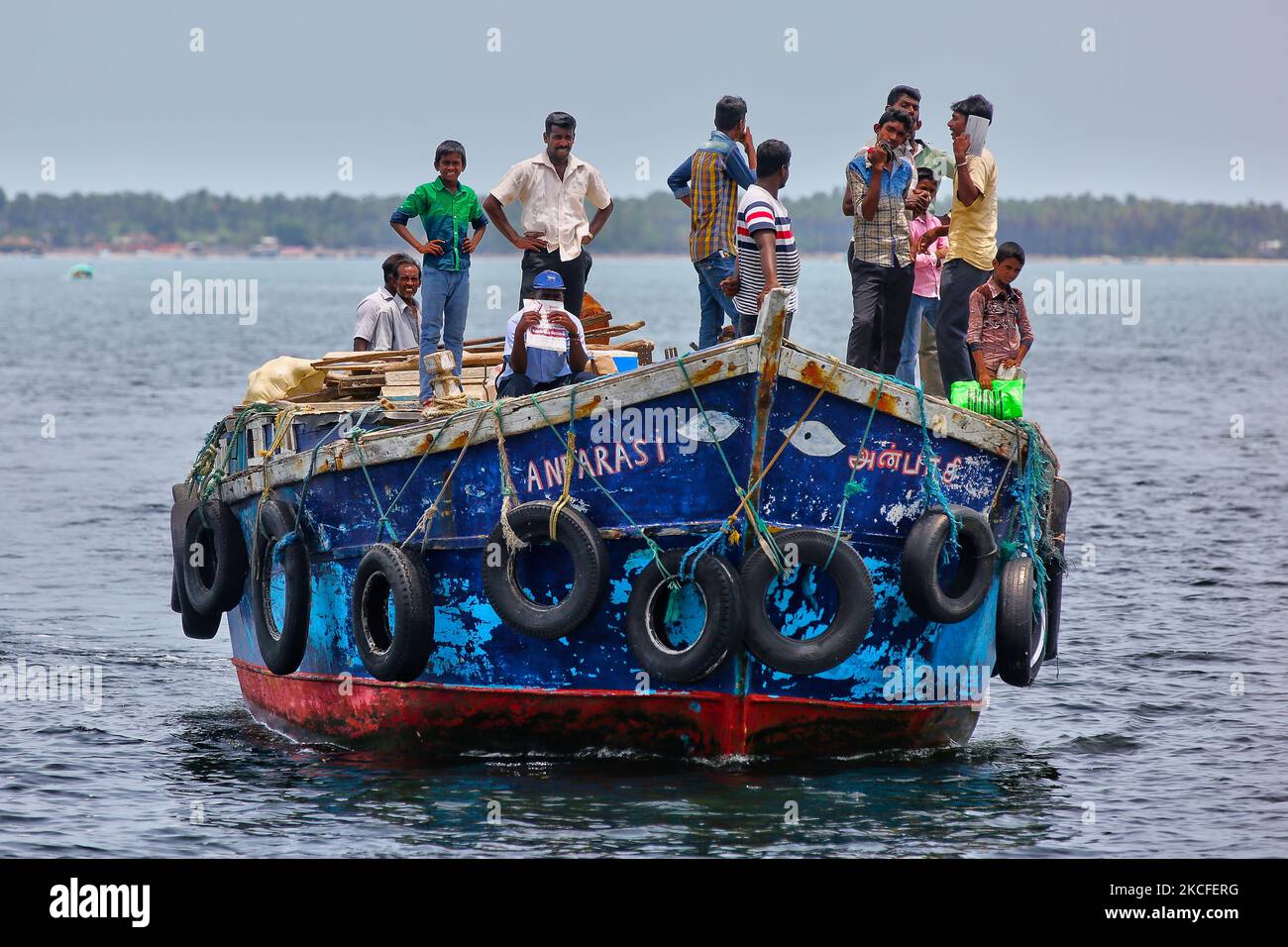 Ferry boat (with most of the passengers seated inside the boat) brings passengers to the Kanaki ...