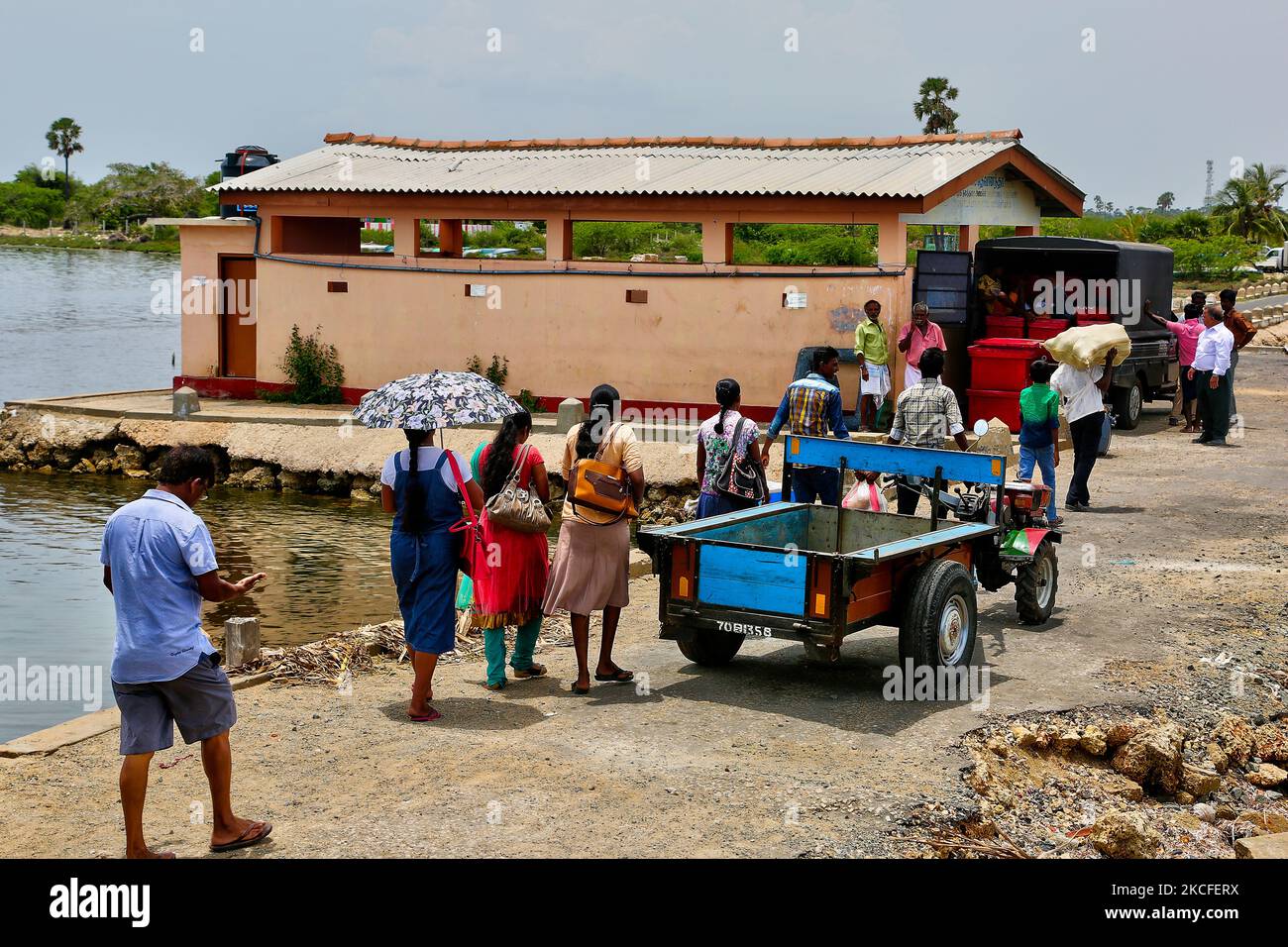 Passengers walk along a dock to the mainland after disembarking from a ferry boat at the Kanaki ...