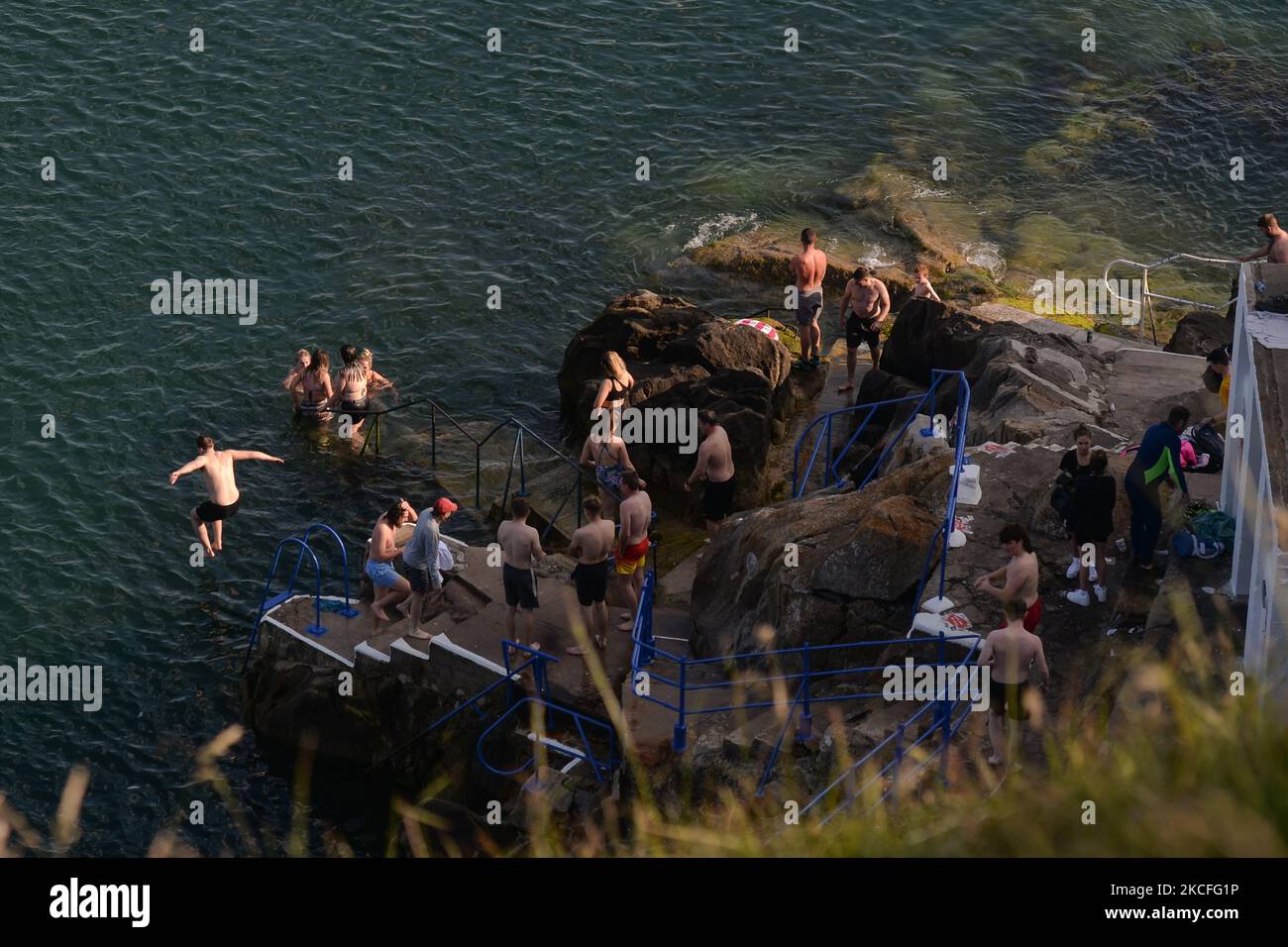 A general view of a crowded Vico bathing place, Hawk Cliff, in Dalkey ...