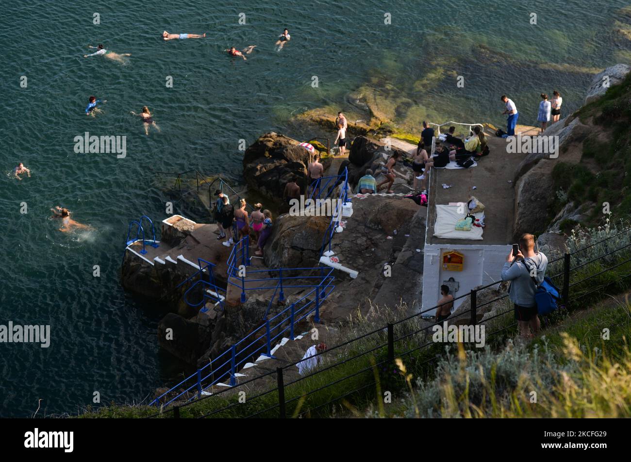 A general view of a crowded Vico bathing place, Hawk Cliff, in Dalkey ...