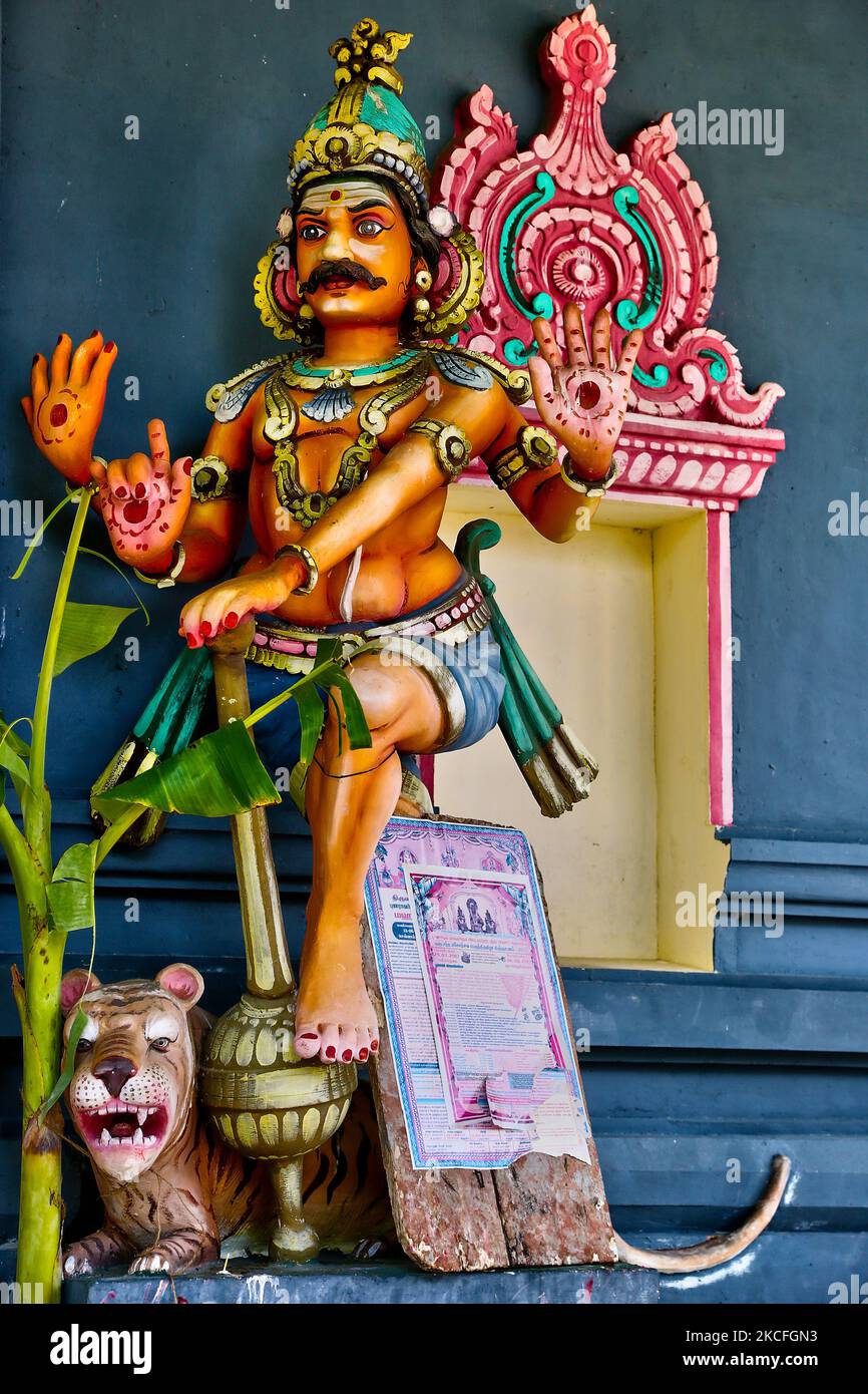 Statue of a guardian figure by the entrance to the Ayyanar Kovil ...