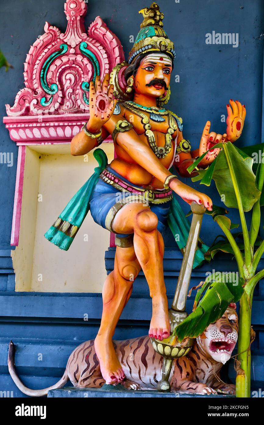 Statue of a guardian figure by the entrance to the Ayyanar Kovil ...