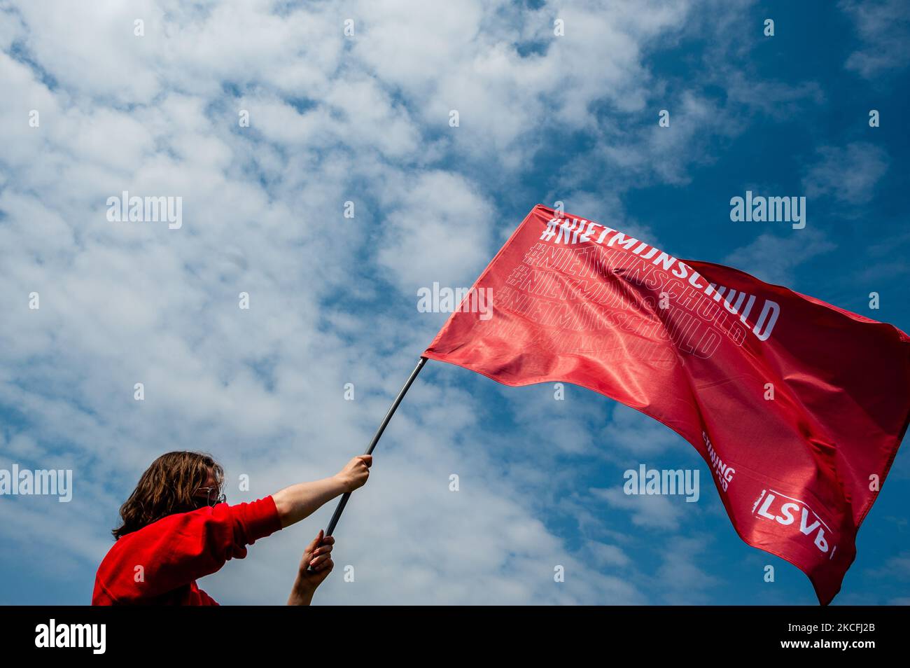 A student is holding a big red flag that says it's not my fault, the ...