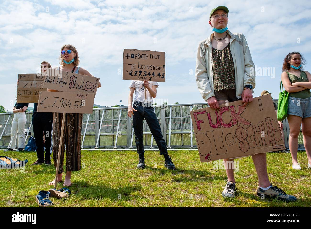 A group of students are holding placards against the student loan ...