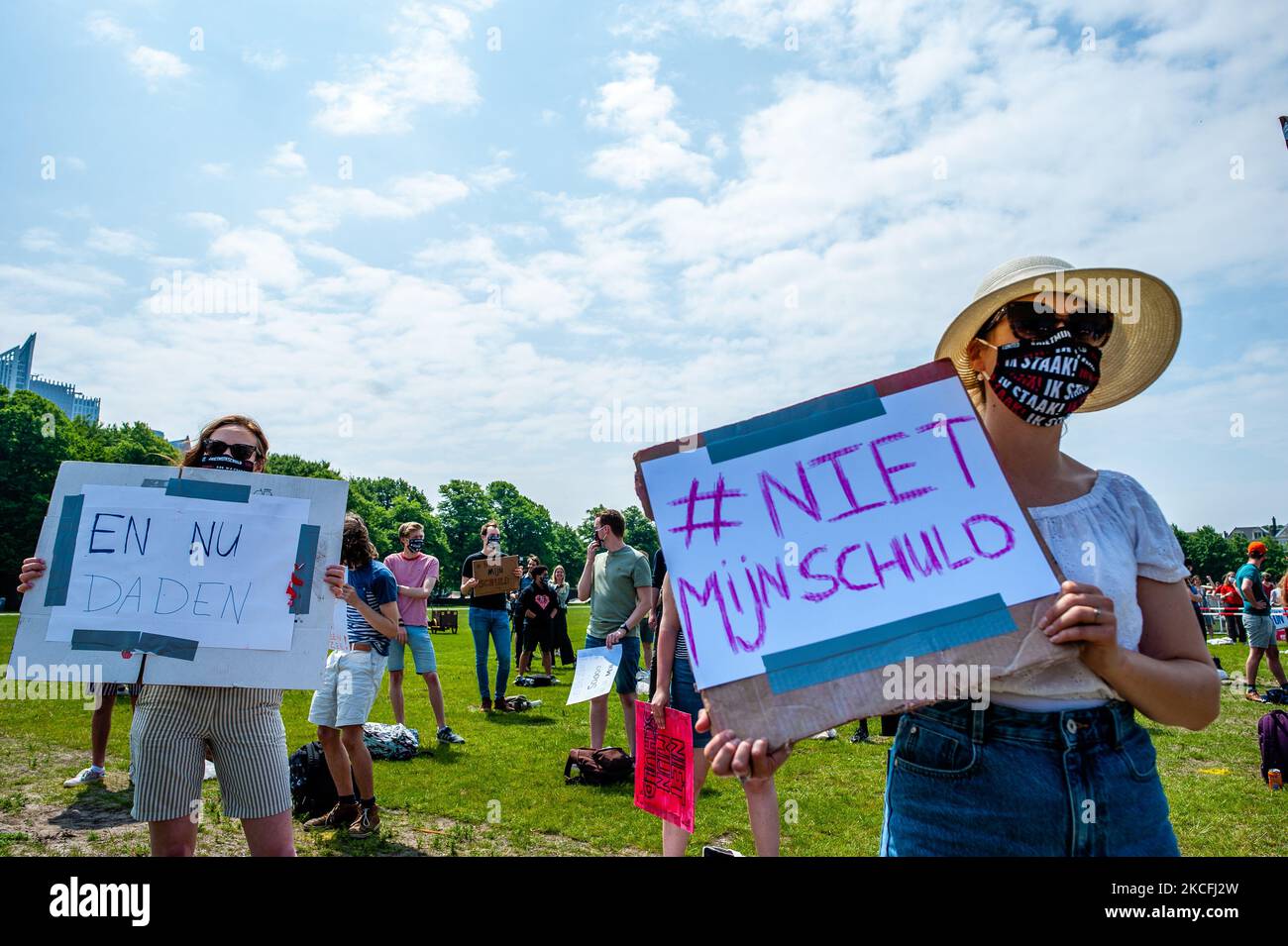 A student is holding a placard that says in Dutch it's not my fault ...