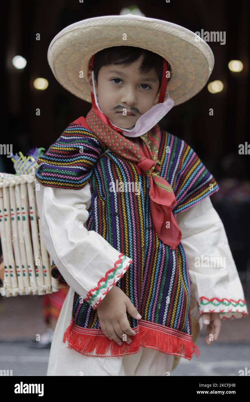 A child wears the costumes of indigenous peoples in Mexico on the ...