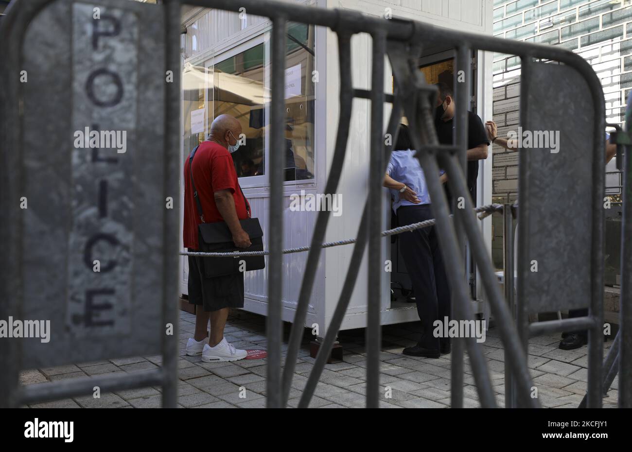 A man waits to cross the re-opened Ledra's Street checkpoint next to ...
