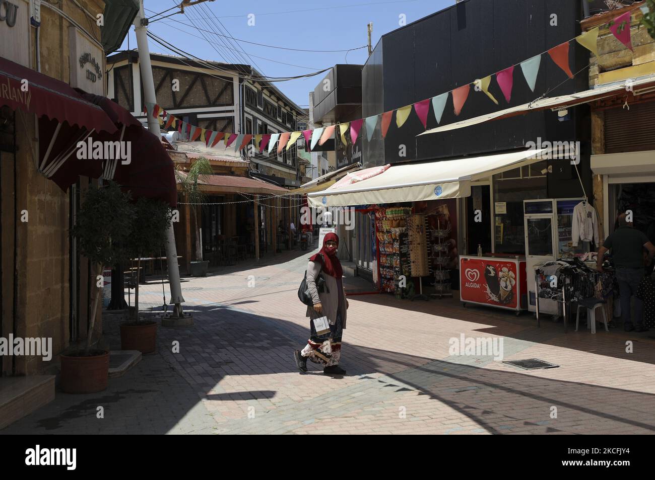 A Turkish Cypriot woman walks down a street in Turkish-occupied ...