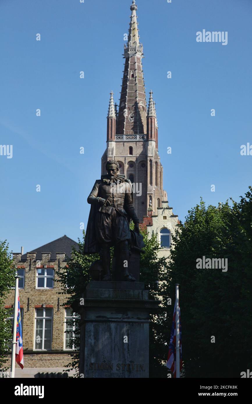 Statue of Simon Stevin by the cathedral tower in the city of Bruges ...