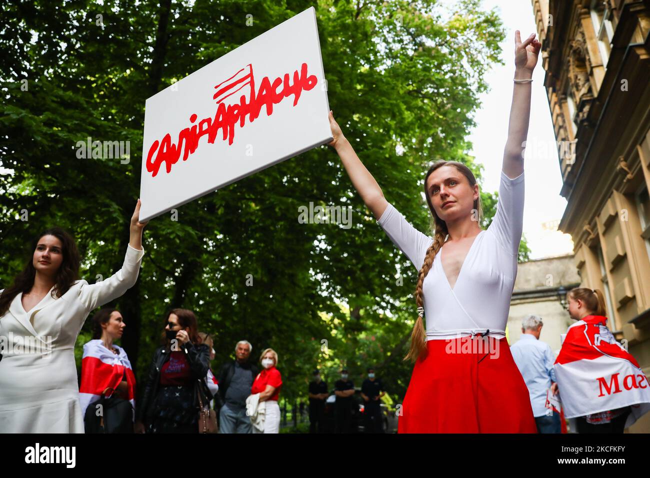 Polish-Belarusian activist Jana Shostak holds a banner saying ...
