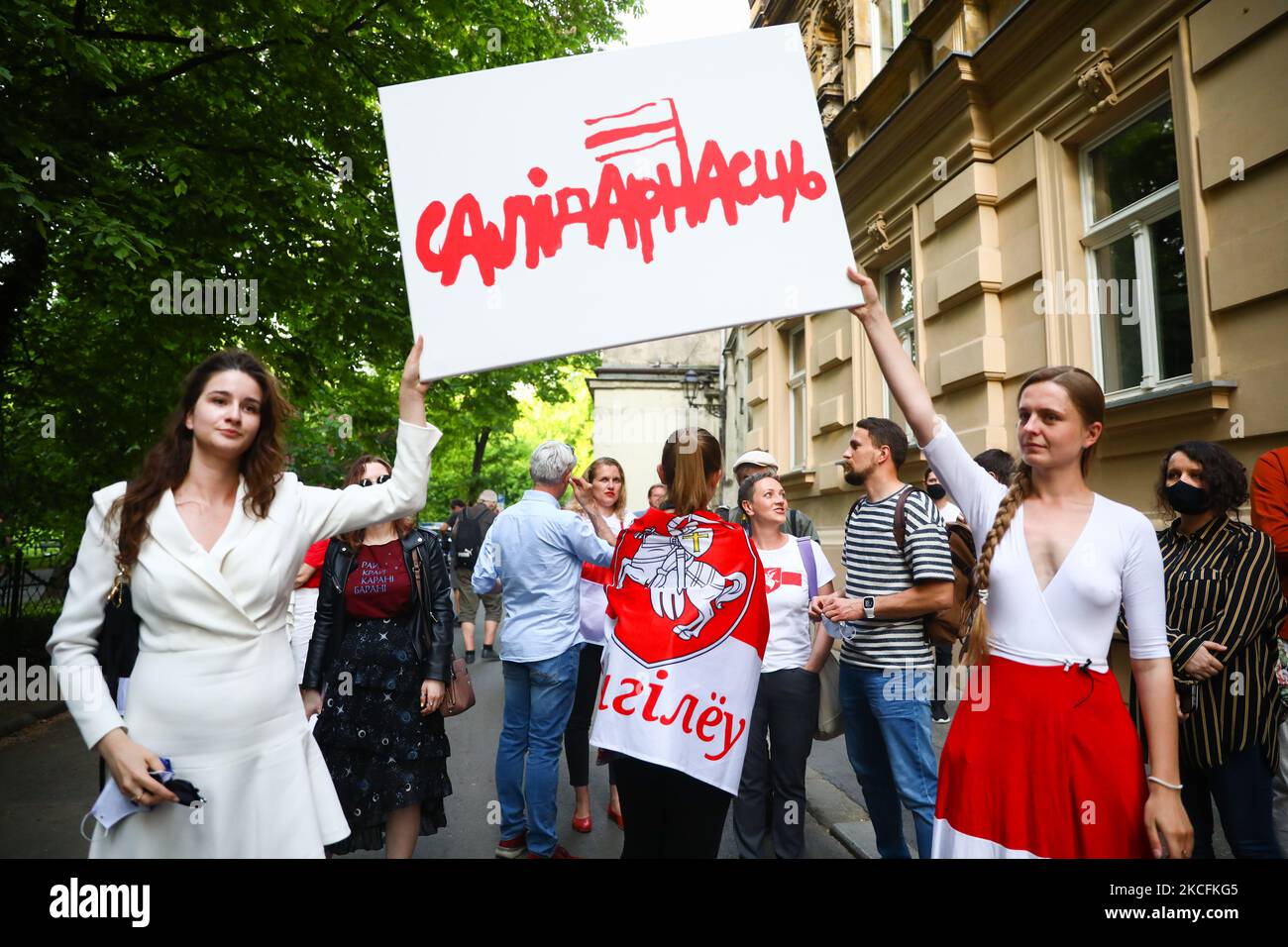 Polish-Belarusian activist Jana Shostak holds a banner saying ...