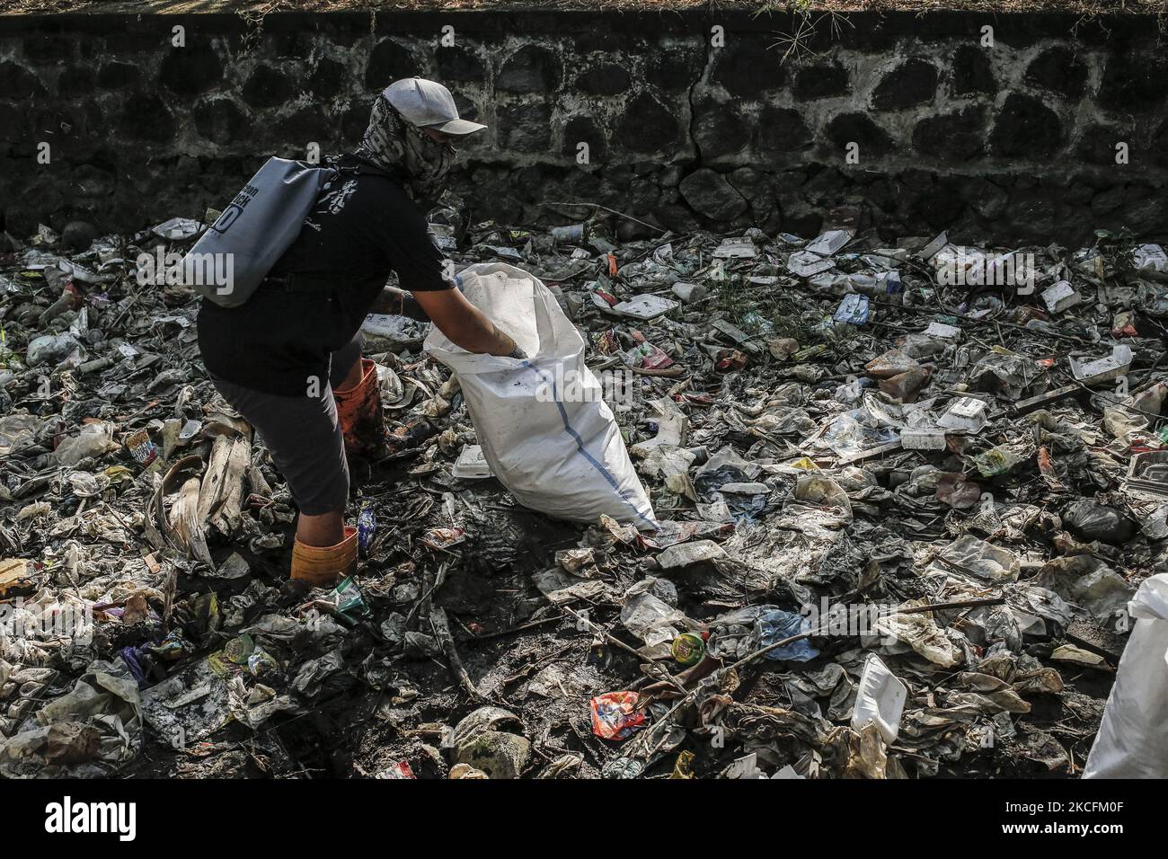Volunteers of Sungai Watch take part in cleaning river canal from ...