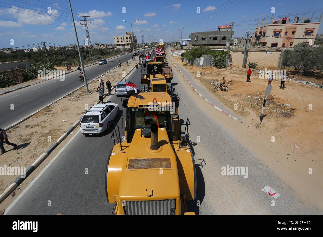 A convoy of bulldozers provided by Egypt arrives at the Palestinian ...