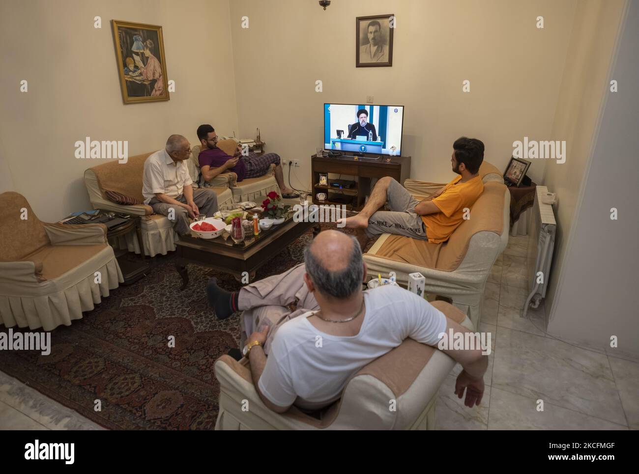 An Iranian family watch the first live televised debate between Iran’s ...