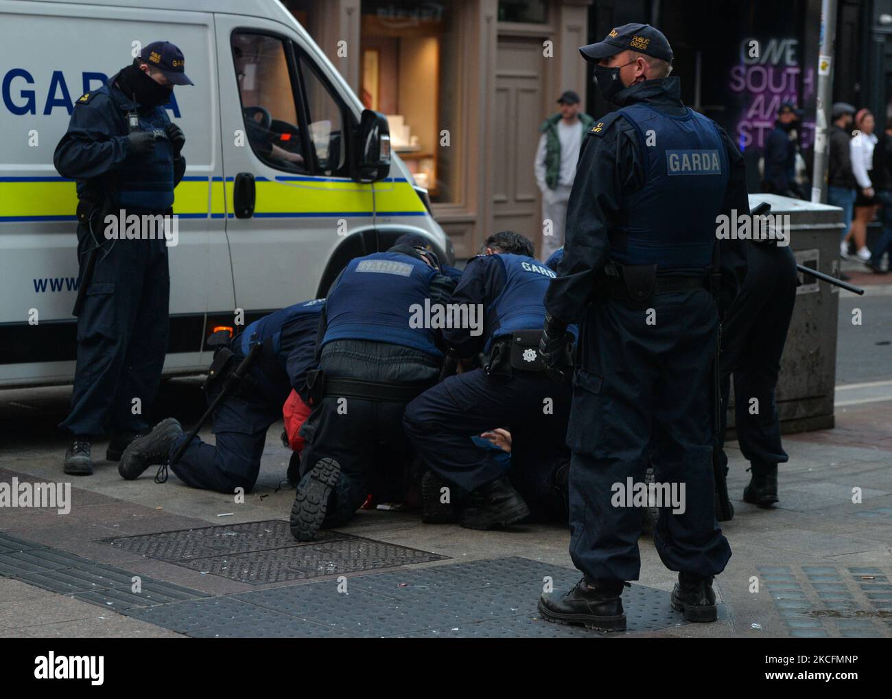 Members of Gardai Public Order Unit arresting a man as they enforce ...