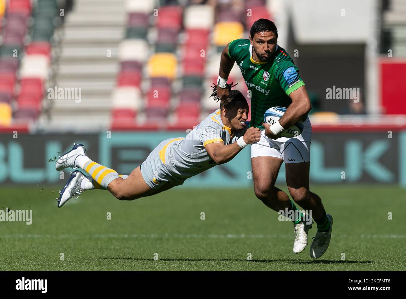 Curtis Rona of London Irish is tackled by Marcus Watson of Wasps during ...