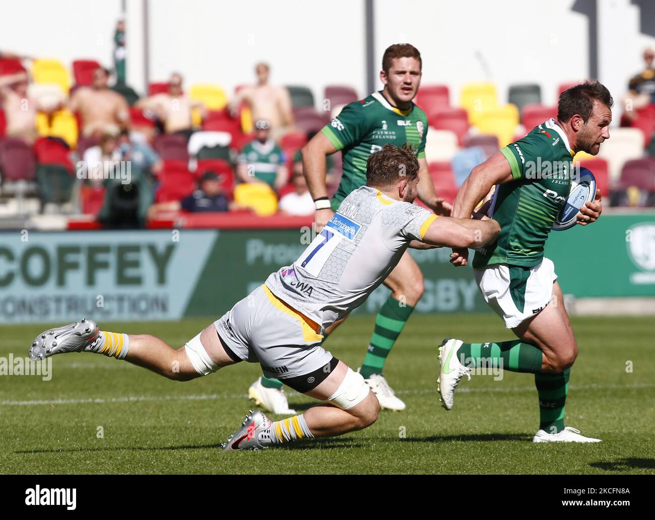 Nic Groom of London Irish gets tackled by Thomas Young of Wasps RFC ...