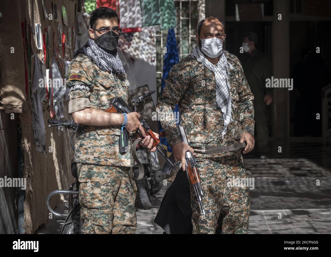 Two armed members of the Islamic Revolutionary Guard Corps (IRGC) looks ...