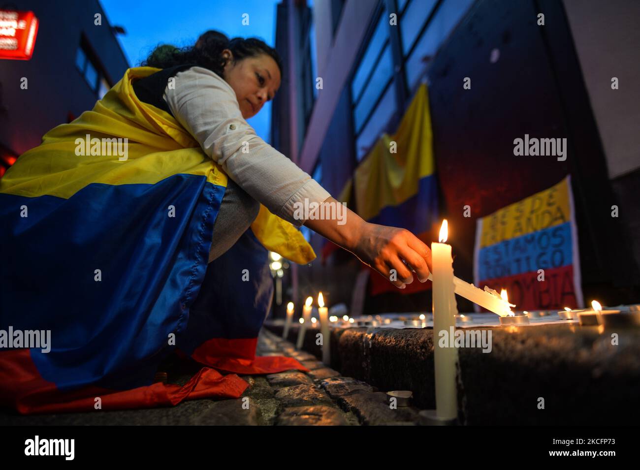 A member of the Colombian Diaspora in Dublin lights a candle during the ...