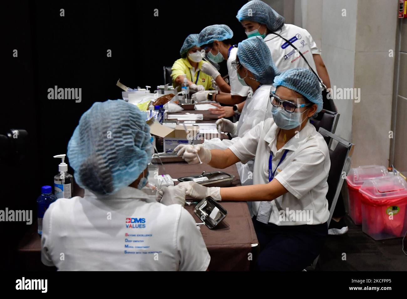 Health workers prepare syringes for administering the AstraZeneca COVID-19 vaccine at ...