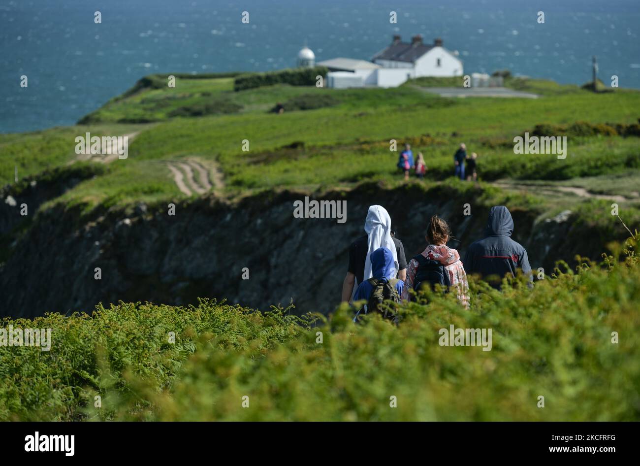 People enjoy nice weather and the Howth cliff path loop walk on the ...