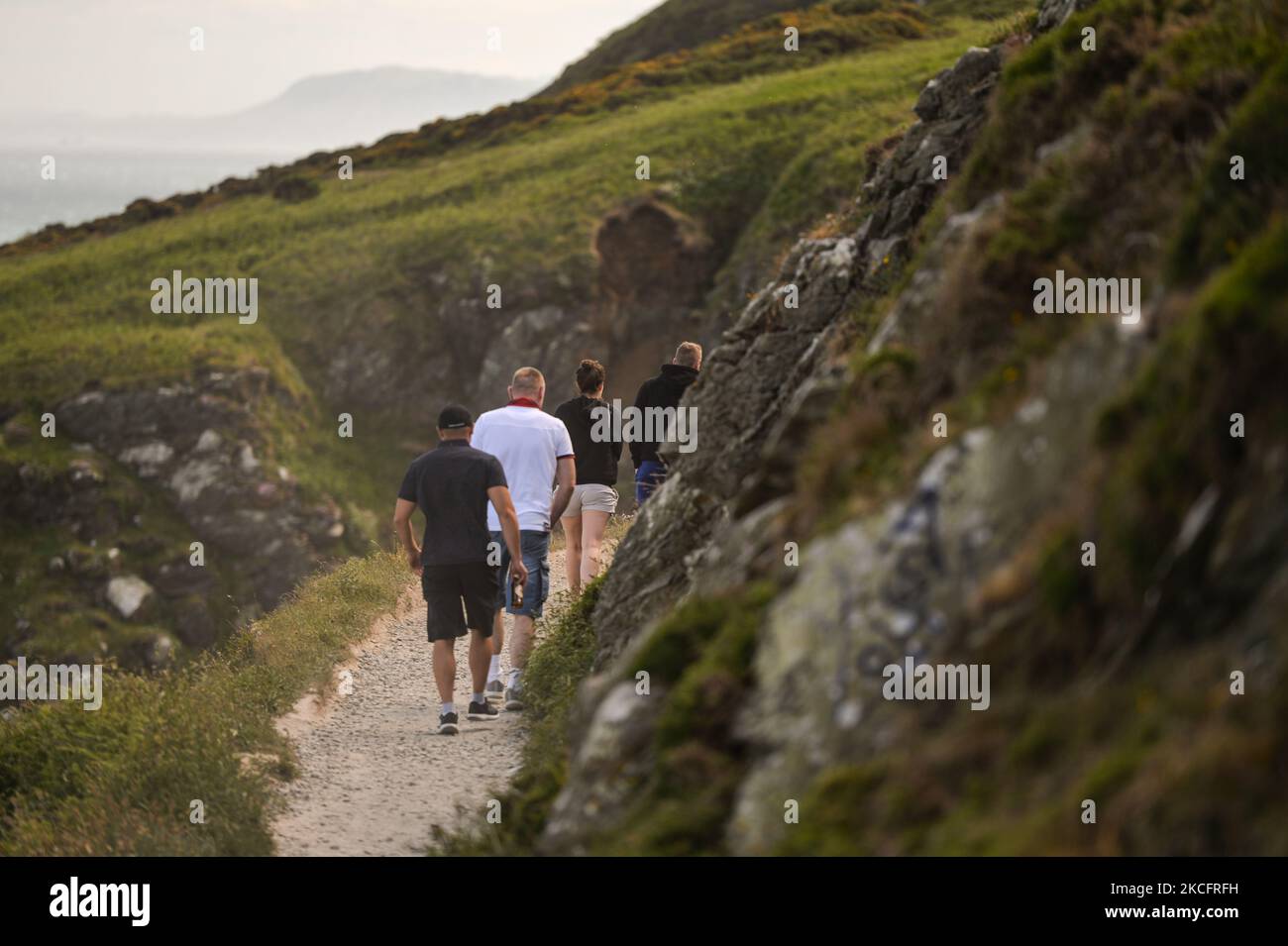 People enjoy nice weather and the Howth cliff path loop walk on the ...