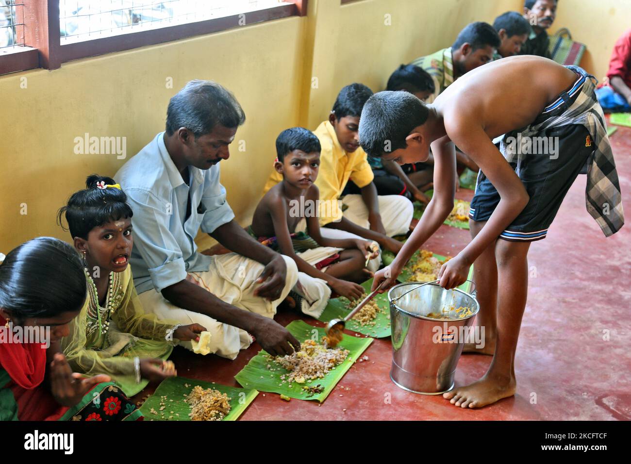 Tamil Hindu devotees eat a traditional vegetarian lunch served on a ...
