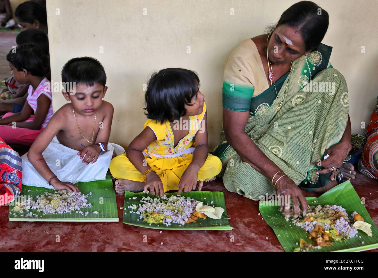 Tamil Hindu devotees eat a traditional vegetarian lunch served on a ...
