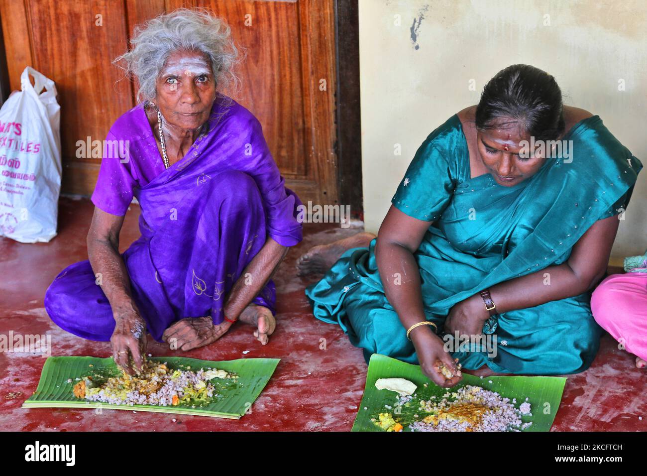 Tamil Hindu devotees eat a traditional vegetarian lunch served on a ...
