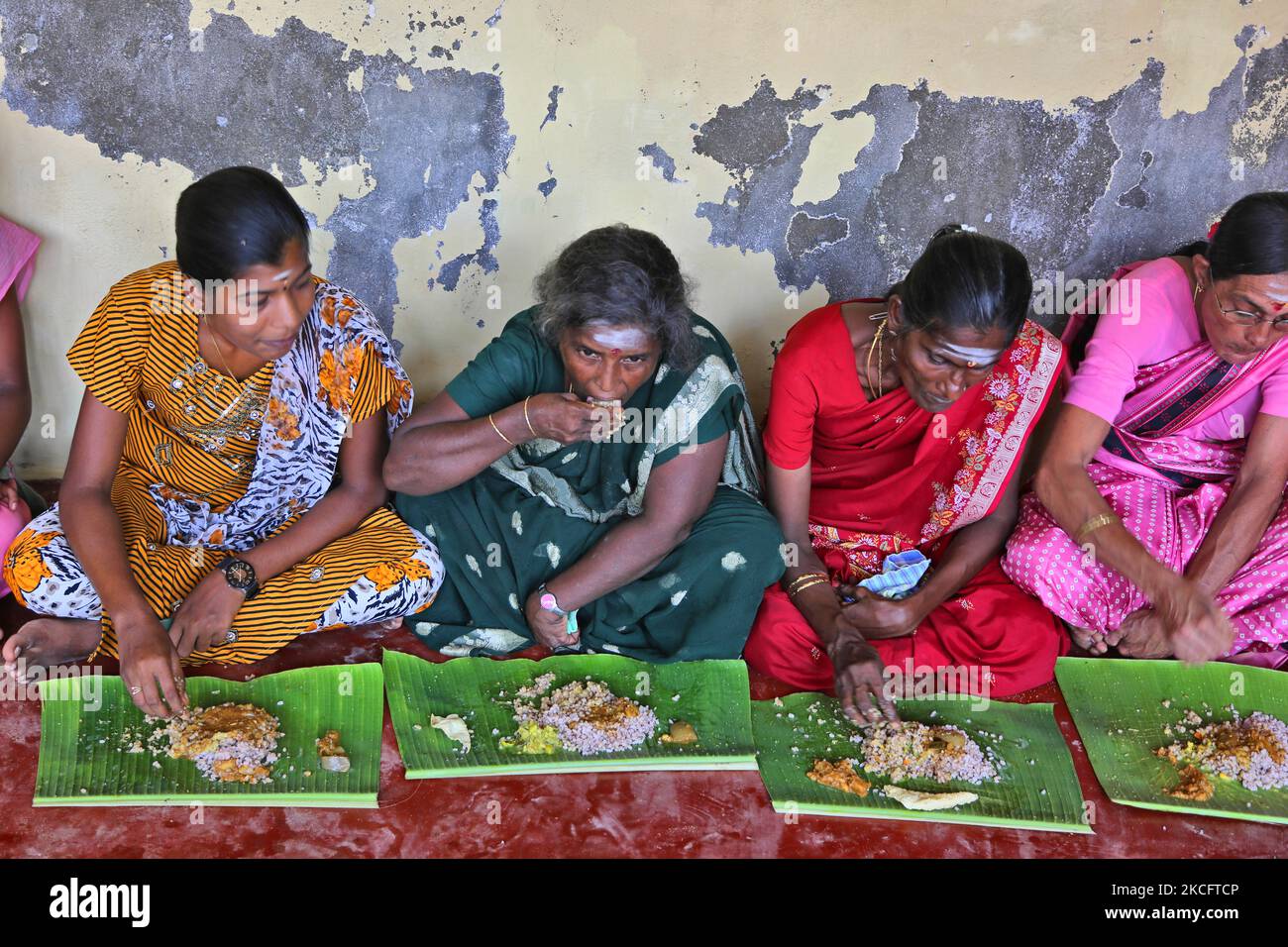 Tamil Hindu devotees eat a traditional vegetarian lunch served on a ...