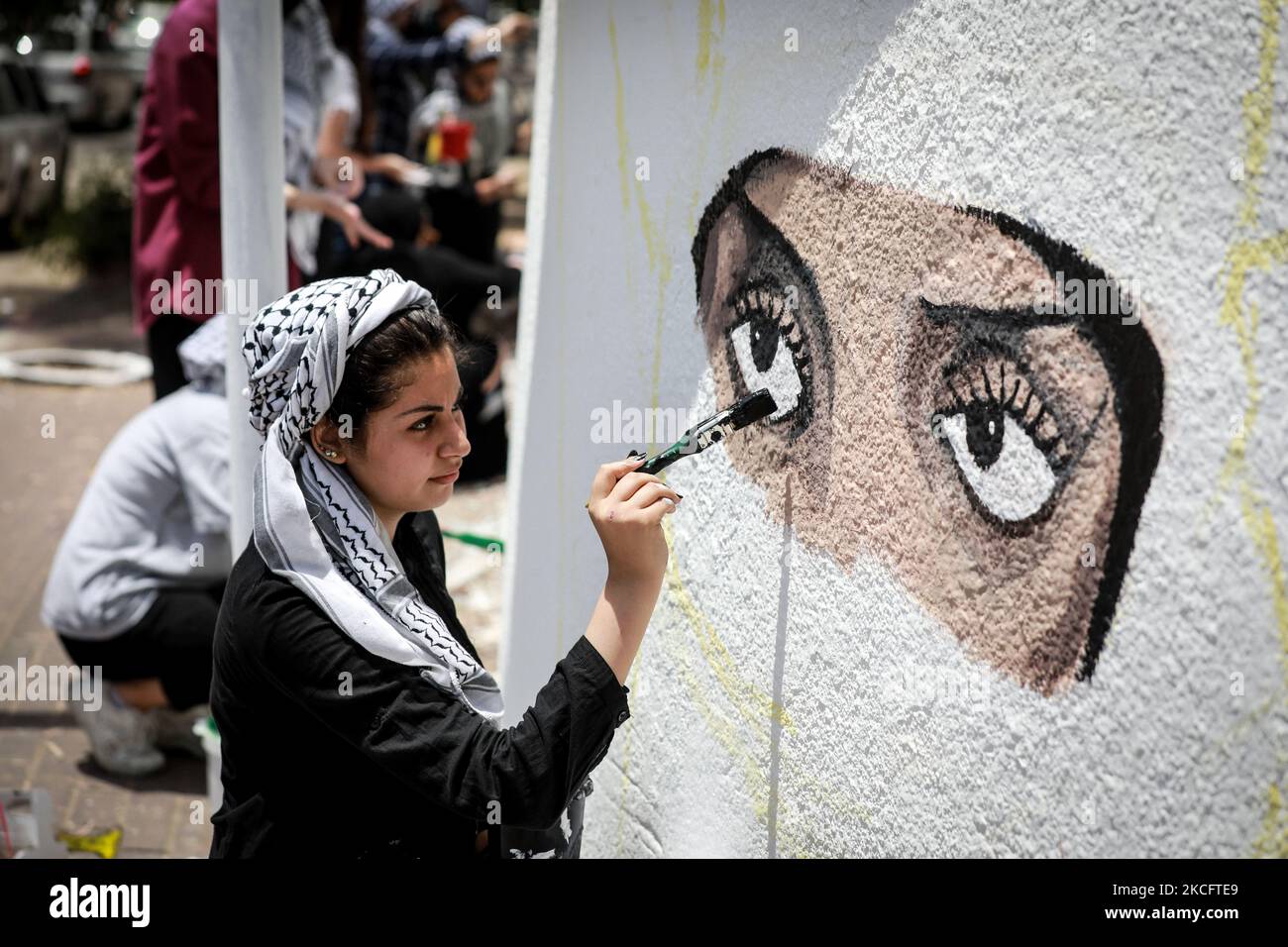 Palestinian artists paint murals in Gaza City on June 8, 2021. (Photo ...