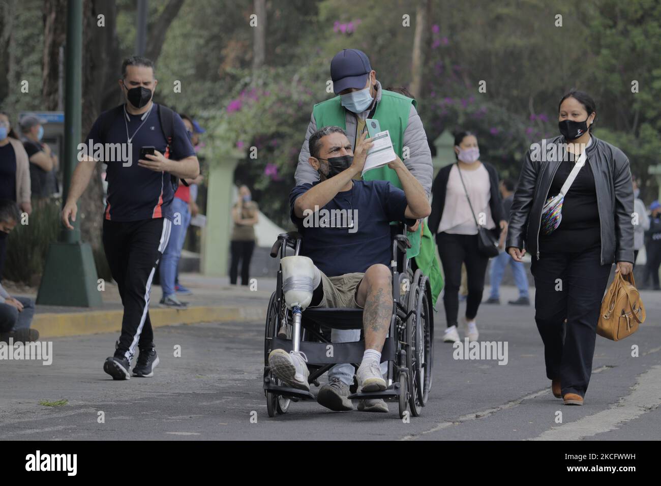 A disabled person in a wheelchair attends a vaccination unit at the ...