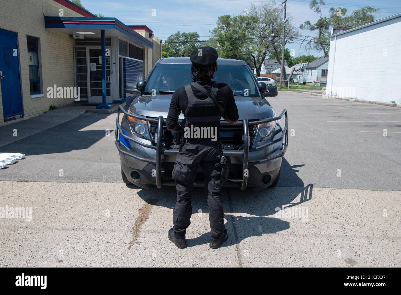 A member of the Young Black Panther Party provides security detail for ...