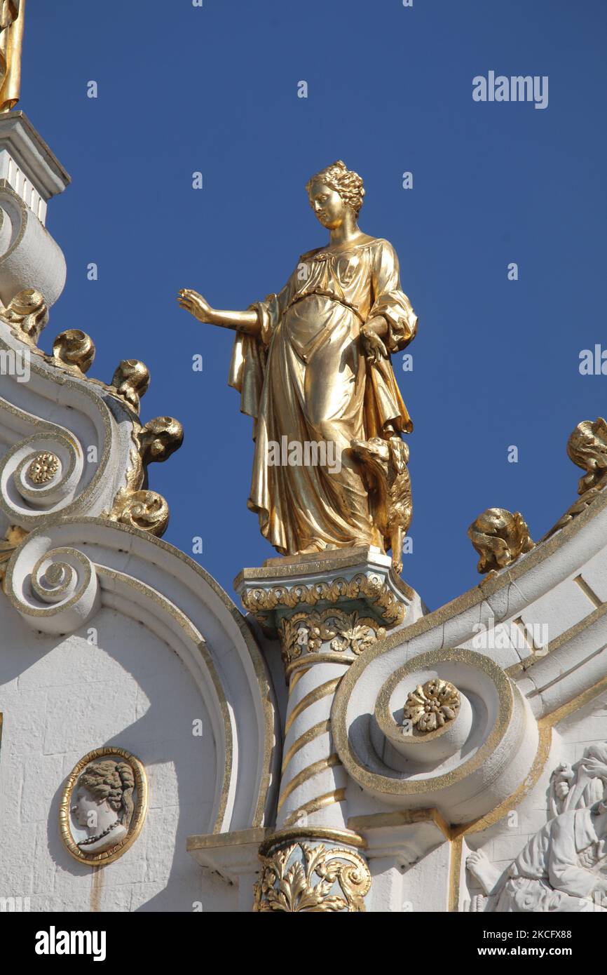Gilded statues adorn the Old Civil Registry building at the Burg Square ...