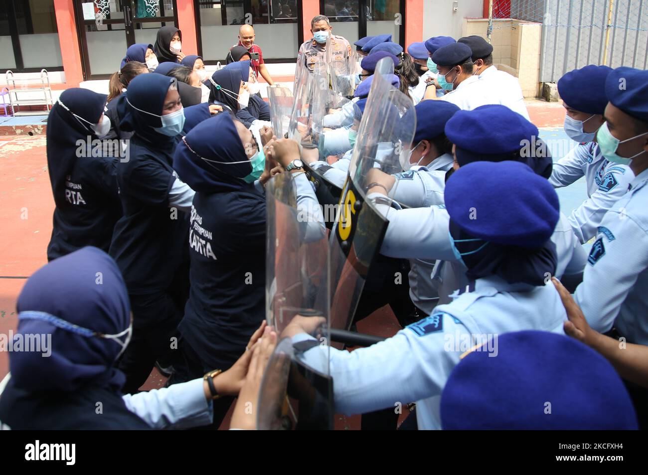 A number of female prison guards conduct training on simulation and ...