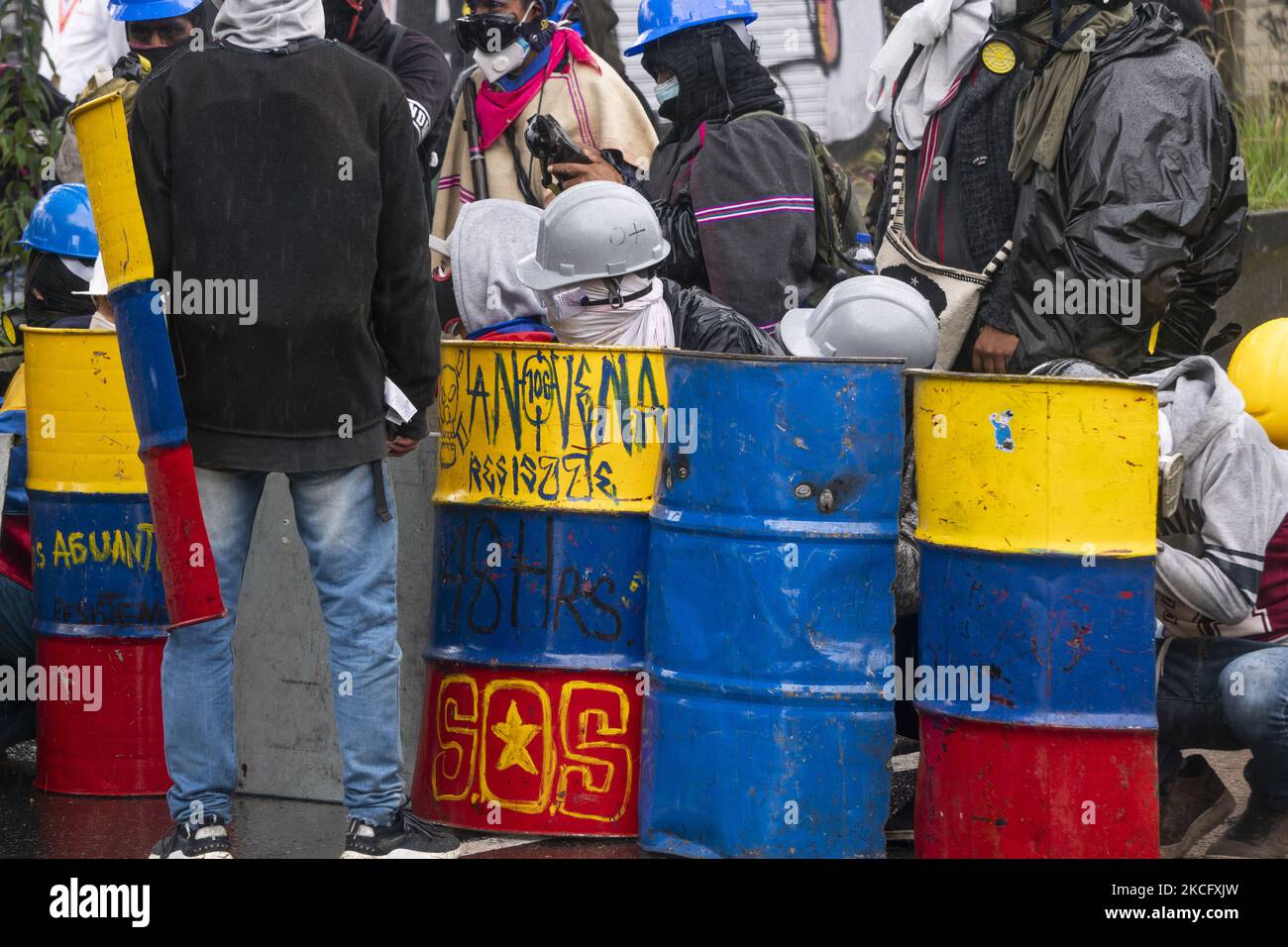 Several members of the front line cover themselves with shields in the ...