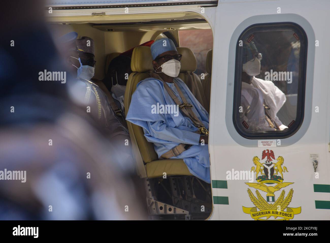 A man of the NigerianPolice stands guard, guarding a helicopter conveying the President Buhari ...