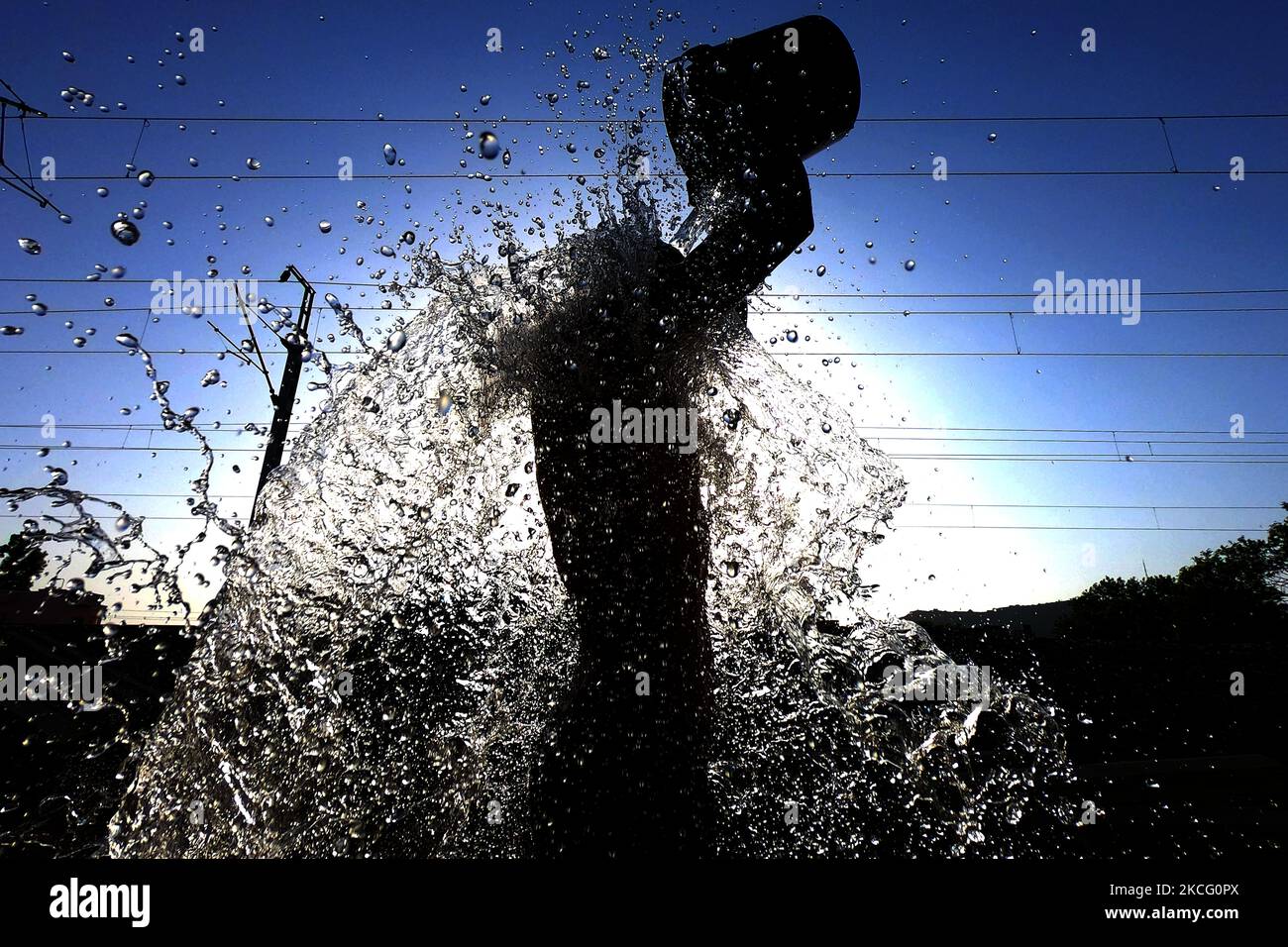 A Man Bathes to cool off from heat amid the boiling hot day in Ajmer in ...