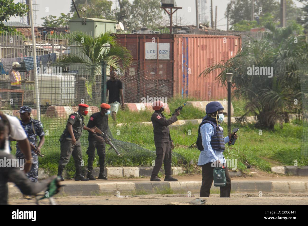 Policemen fire a tear gas canister at protesters during civil ...