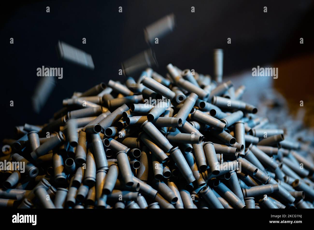 Shell casings fall down in ammunition production workshop Stock Photo ...