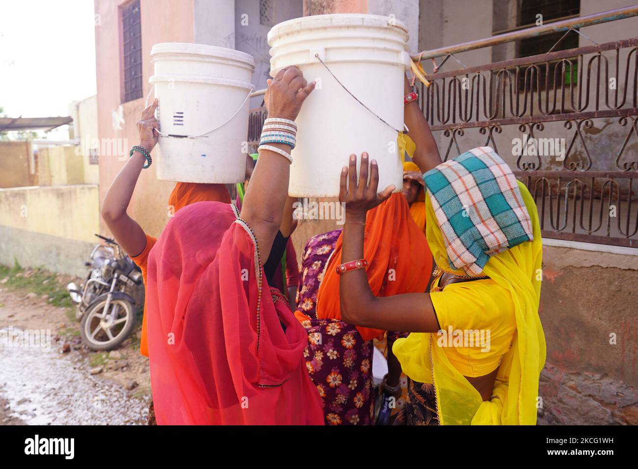 Indian Villagers collects drinking water from a road side water tap ...