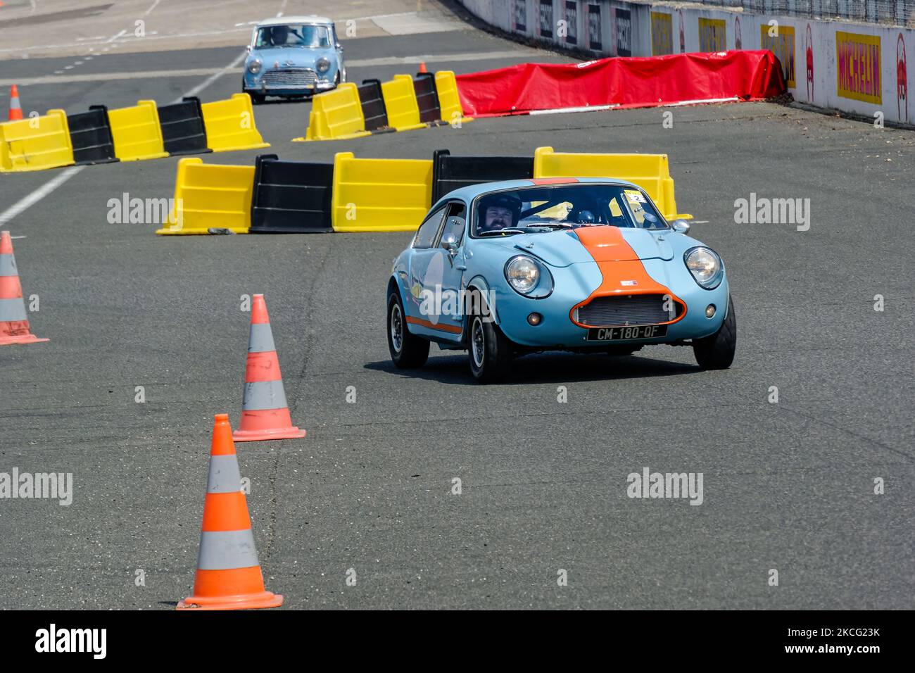 A Rare Mini Marcos ahead after the chicanes in front of an Austin Mini ...