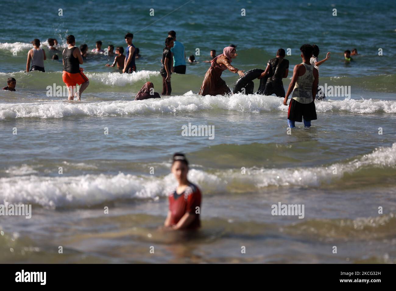Palestinians enjoy the beach of the Mediterranean sea in Gaza City, on ...