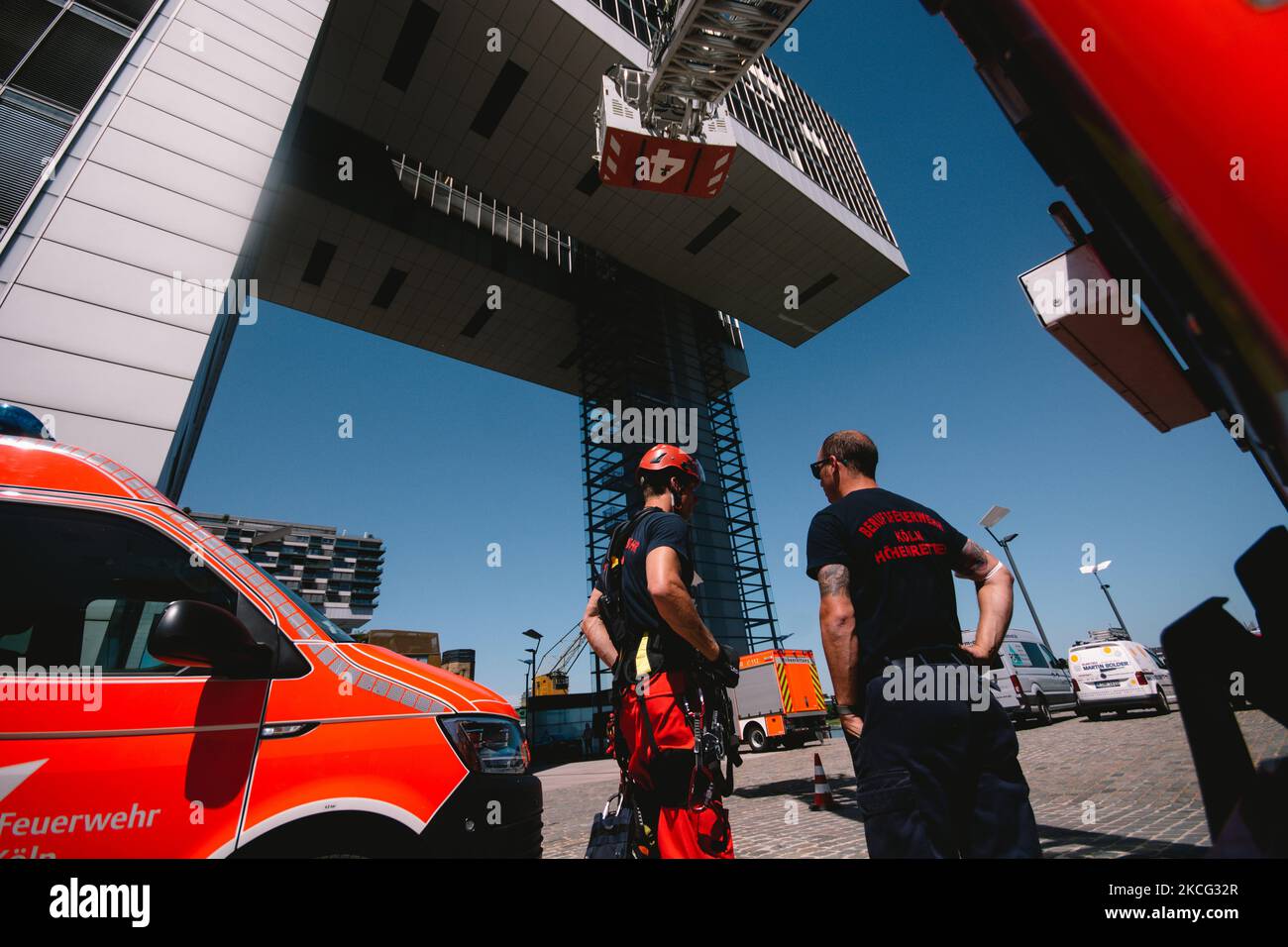members of the Cologne Firefighters are seen in front of Kranhaus ...
