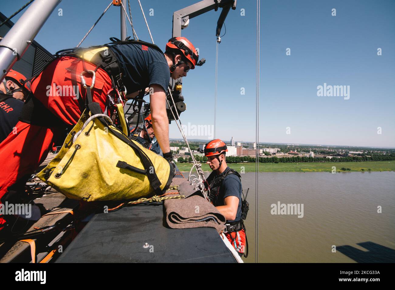 members of the Cologne Firefighters are seen on top of the Kranhaus ...