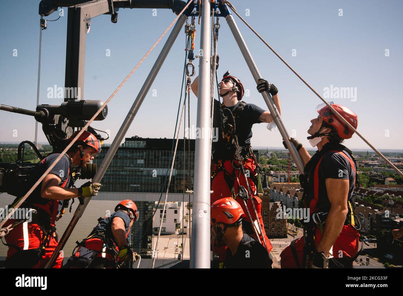 members of the Cologne Firefighters are seen on top of the Kranhaus ...