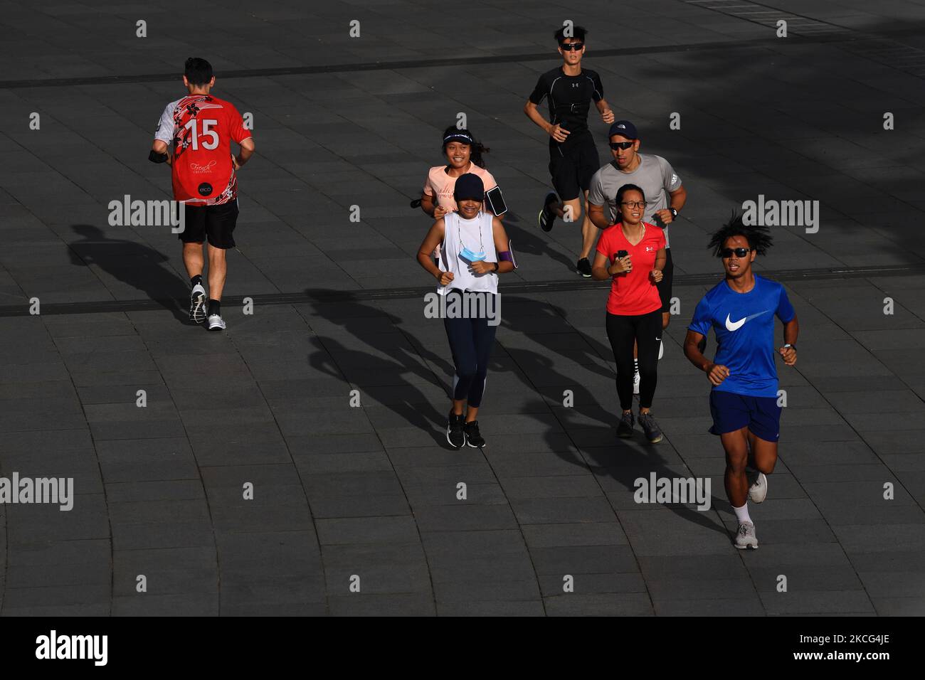 People jog along the bayfront on June 16, 2021 in Singapore. On June 14 ...