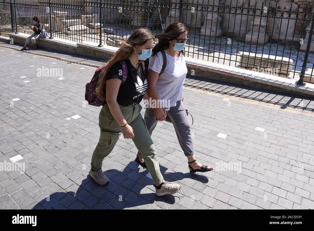 Members of the public walk through the streets of Athens, Greece on 16 ...